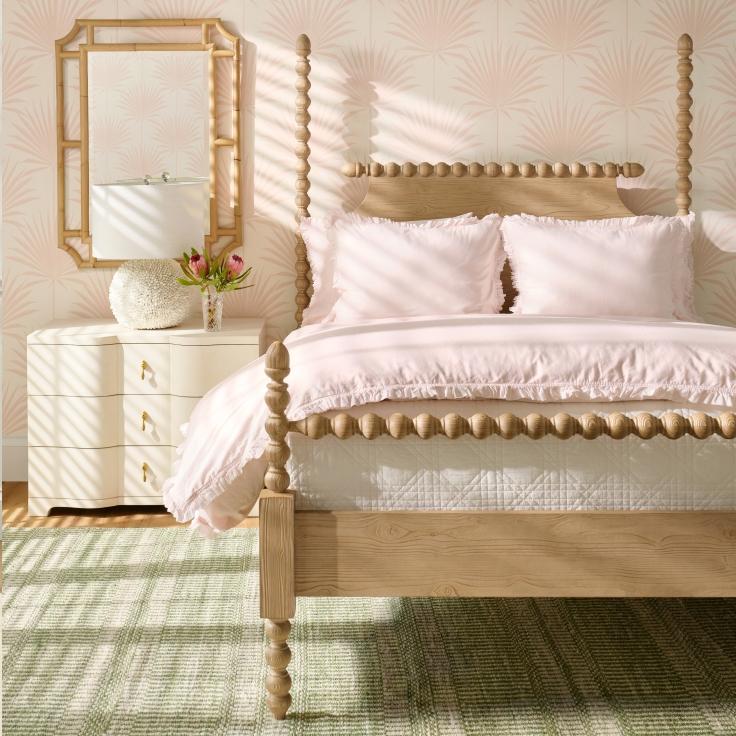 pink and green bedroom with spindle bed
