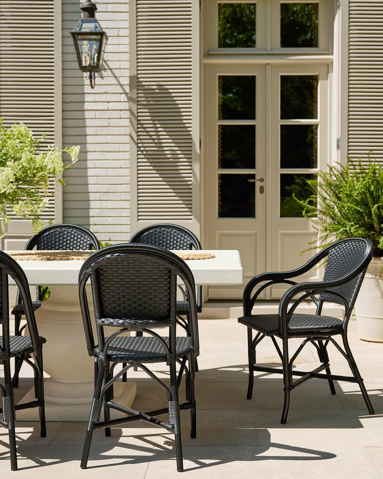 Outdoor-Dining-Stone-Terrace-Table-Black-Chairs-brand-x0434_CV1