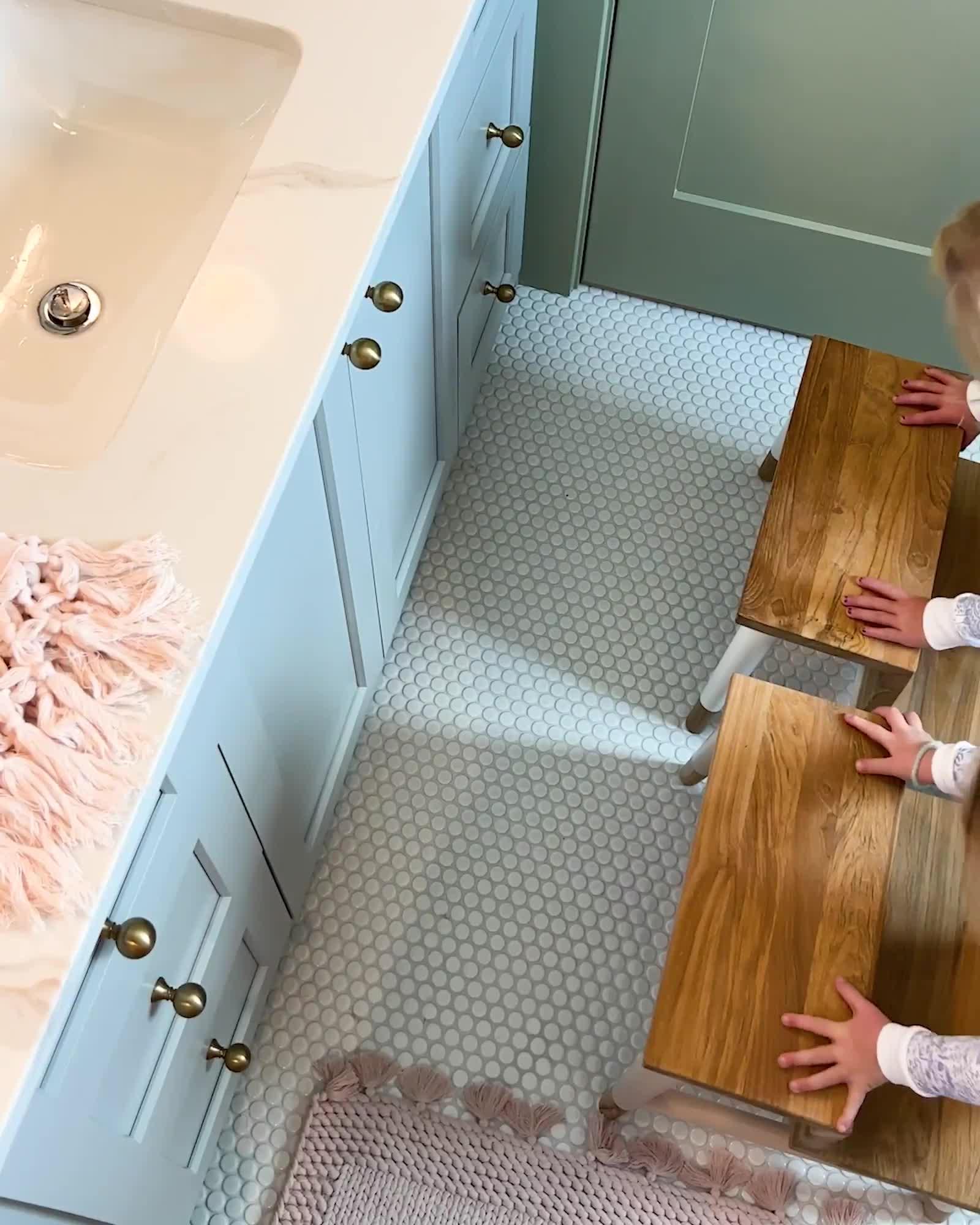 Teak step stools in kids bathroom